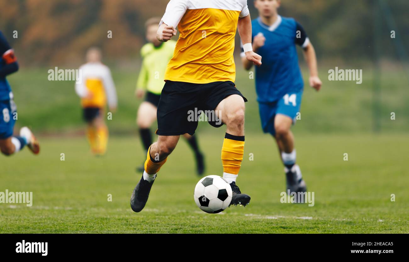 Adult Football Players Kicking Soccer Ball. Soccer Competition Between ...