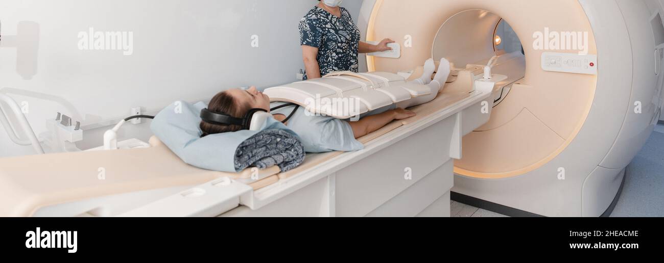 Doctor or nurse and patient with tomography CT or MRI Scan in hospital ...