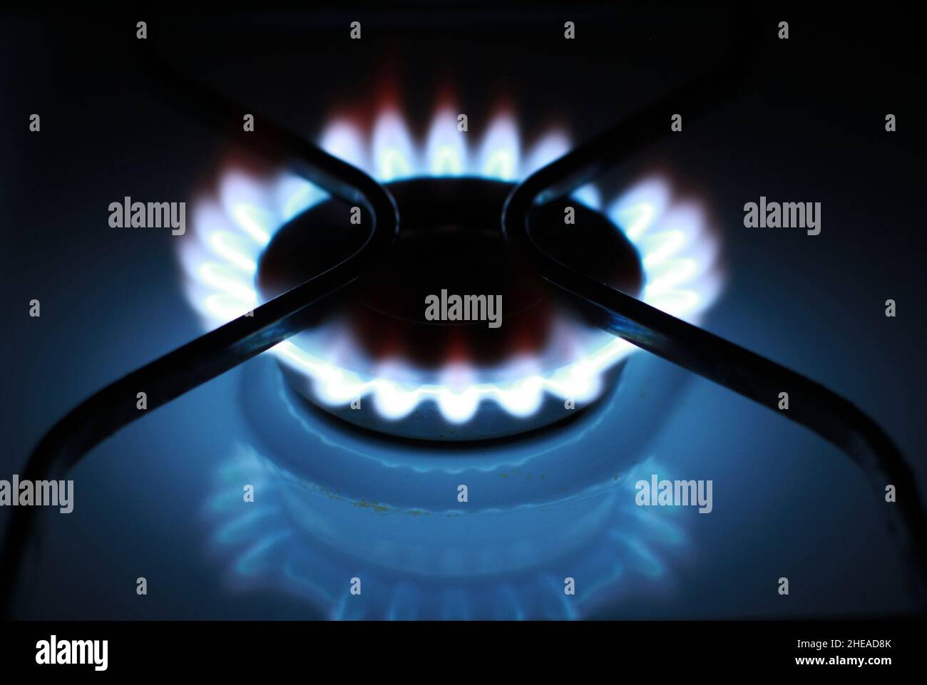 Gas ring with blue and red colored fire in the darkness Stock Photo - Alamy