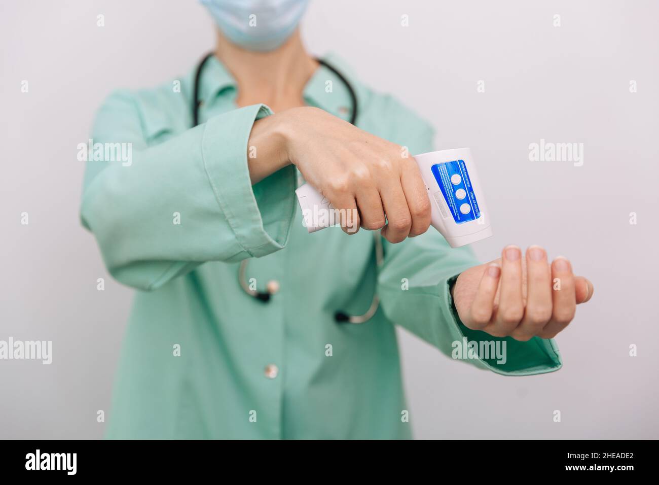 Temperature measurement gun in doctor hands. Close-up shot of doctor ...