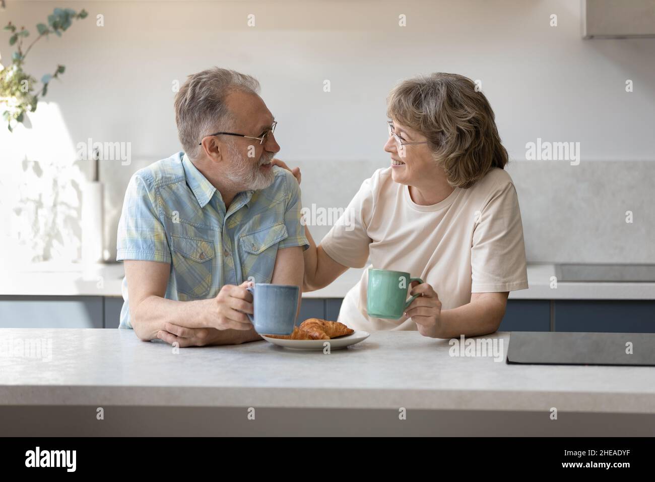 Happy bonding middle aged family couple eating breakfast Stock Photo ...