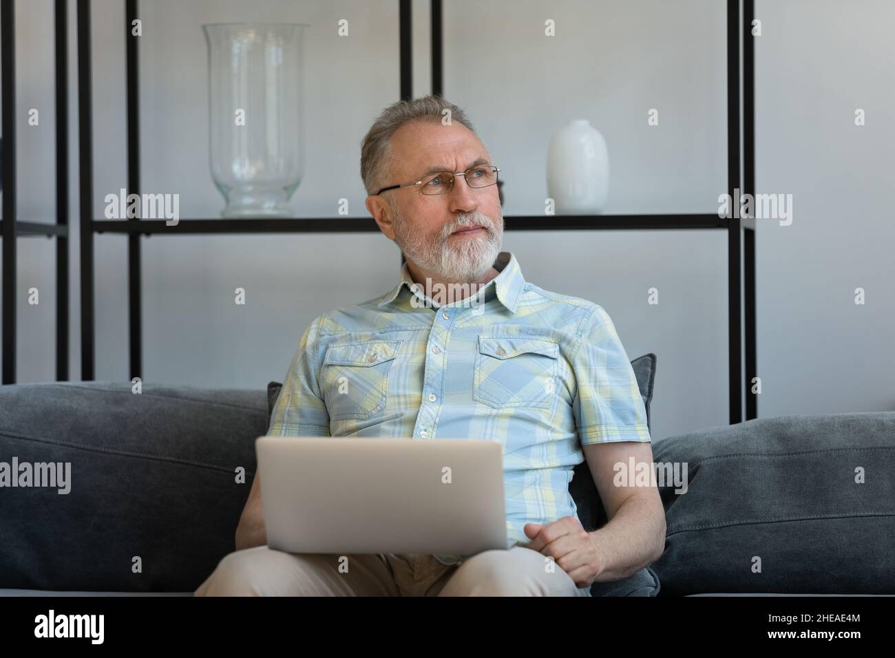 Pensive old man working on computer at home Stock Photo - Alamy