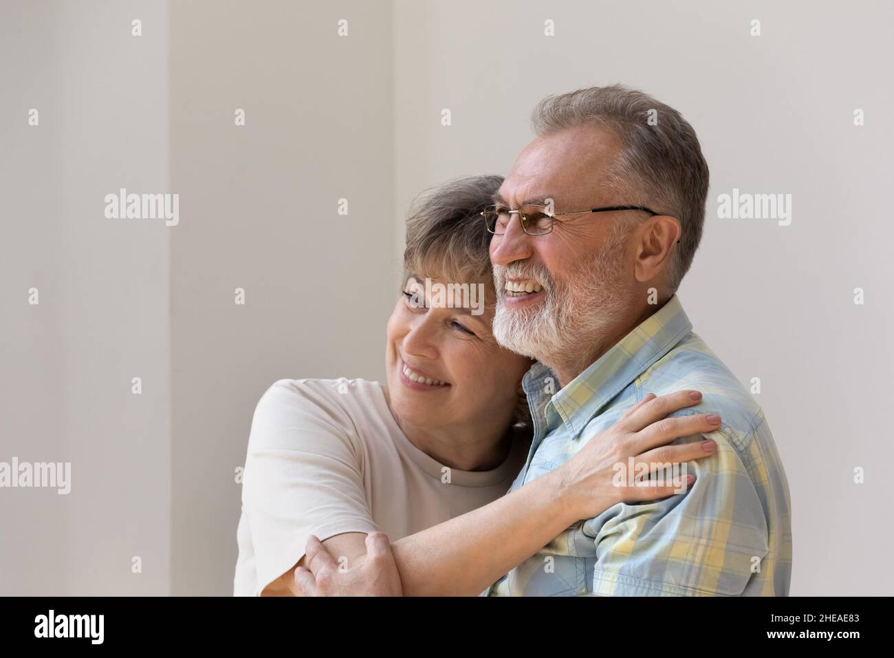 Happy bonding mature couple looking in distance Stock Photo - Alamy