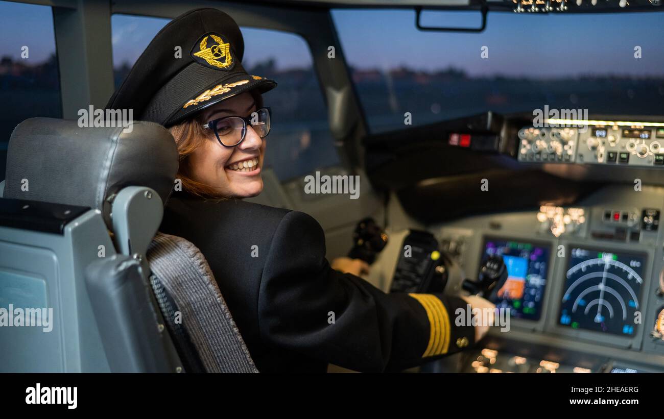 Female pilot on board the aircraft. Caucasian woman in flight simulator ...
