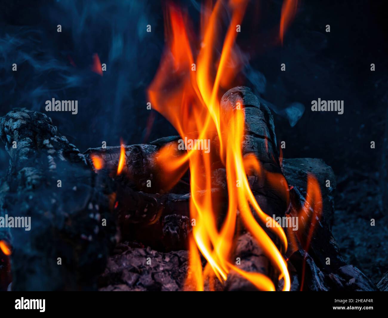 Orange flames of fire of a wood fire. The heat of a wood fire. Tourist ...