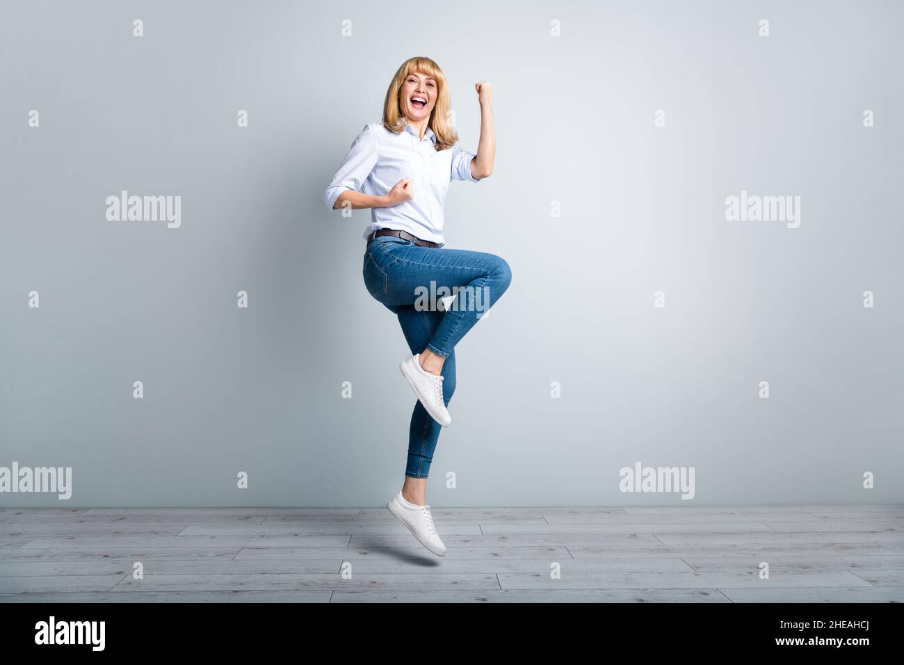 Full size photo of ecstatic lady marketer jump up office fists up ...