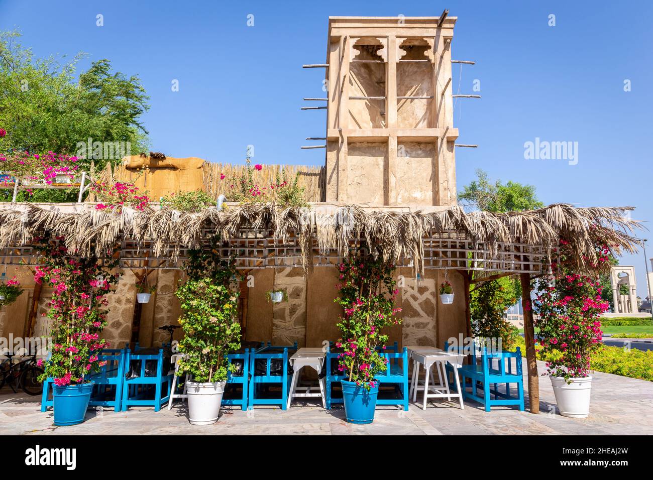 Traditional Arabic style building with windcatcher tower and palm ...