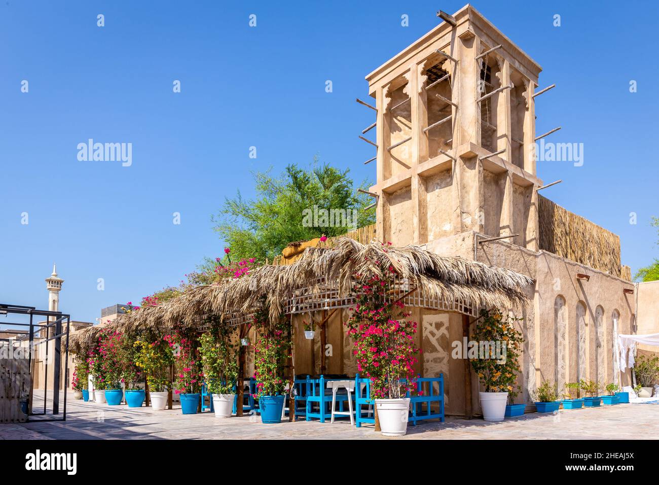 Traditional Arabic style building with windcatcher tower and palm ...