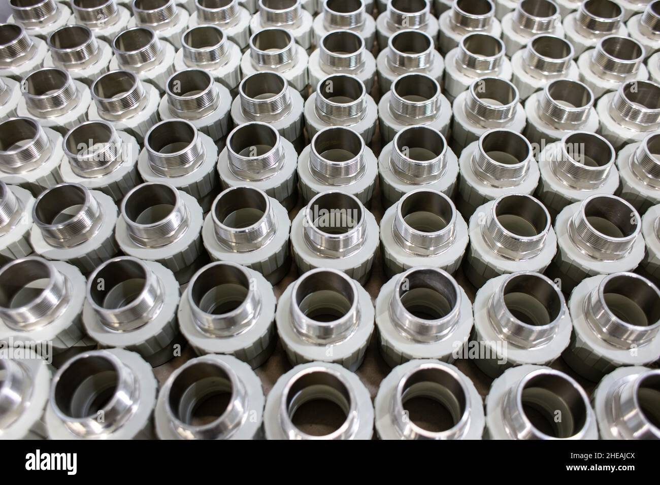 many metal pipe couplings in a pipe factory Stock Photo - Alamy