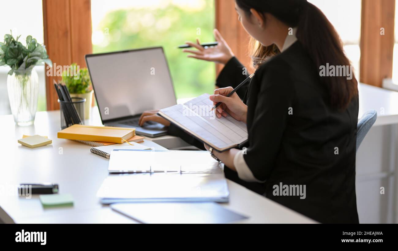 Female assistant and her manager working together in the office ...