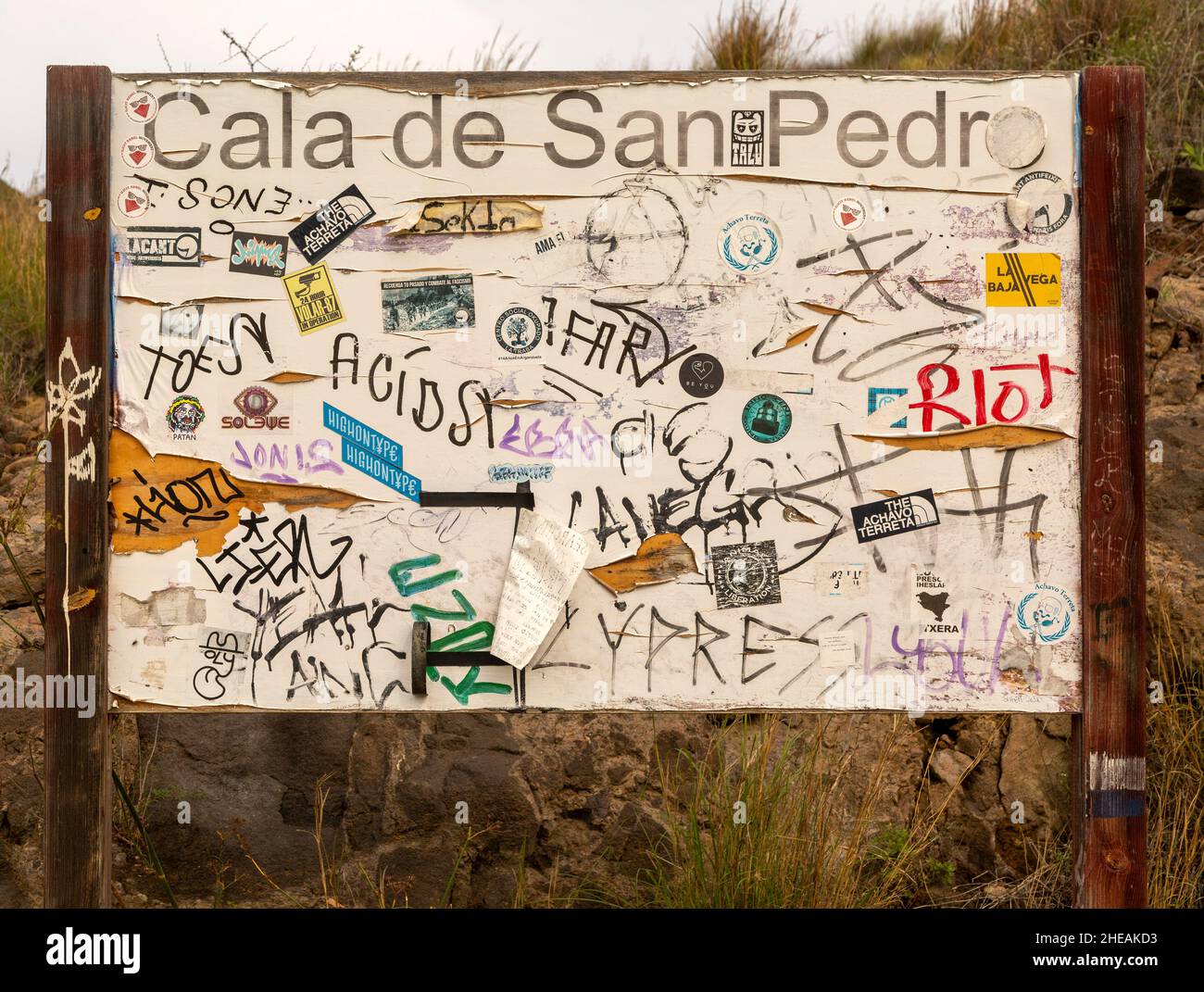 Hippy graffiti painted on noticeboard , abandoned village of Cala de ...