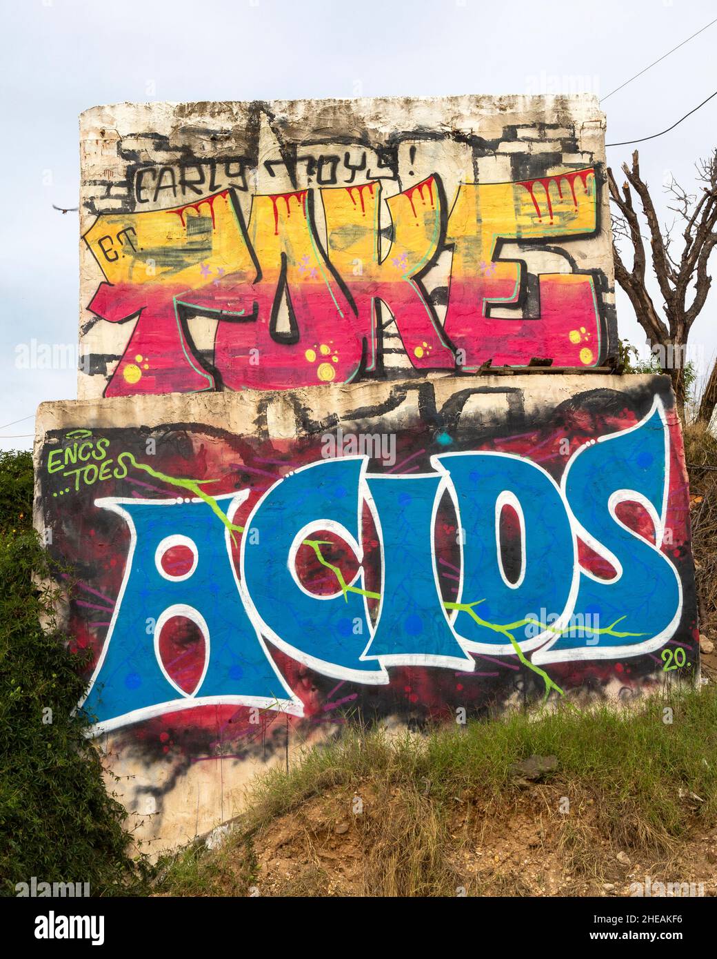 Hippy graffiti painted on wall on route to abandoned village of Cala de ...