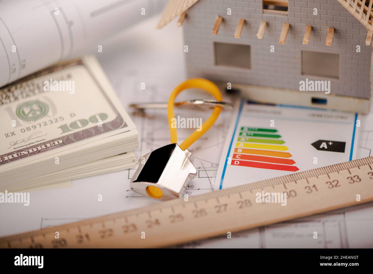 A model home and house key on architectural floor plans. Close up Stock ...