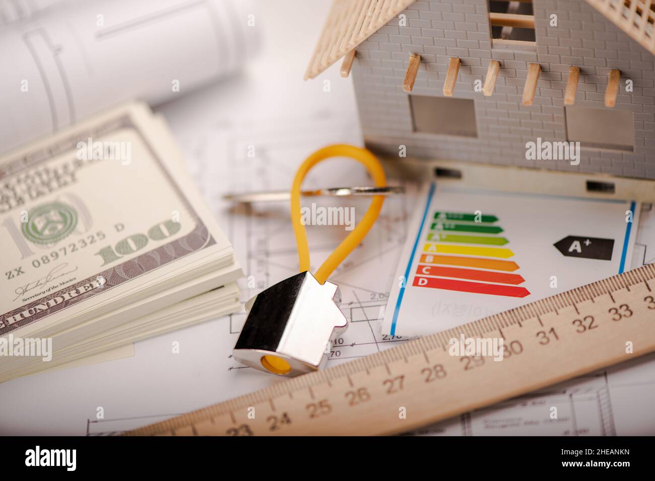 A model home and house key on architectural floor plans. Close up Stock ...