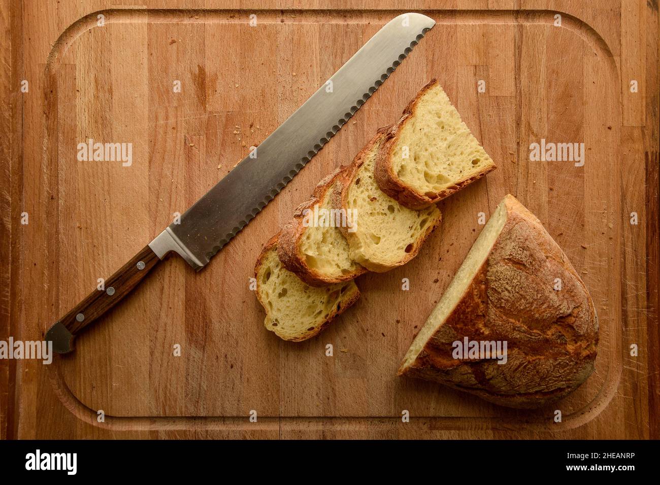 Bread knife on a Wooden Table isolated Stock Photo - Alamy
