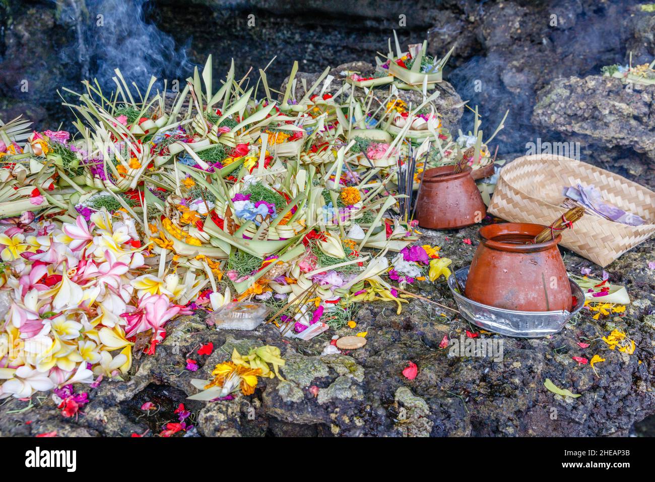 Traditional Hindu Balinese offerings canang sari and clay pots with ...