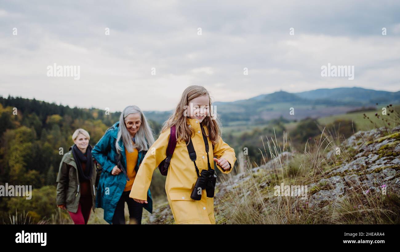 Small girl with mother and grandmother hiking outoors in nature Stock ...