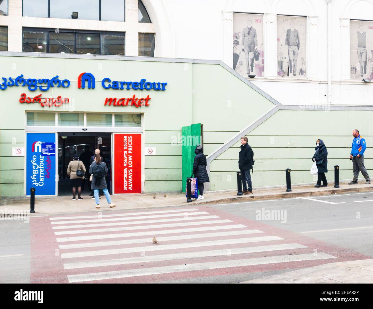 Customers outside carrefour supermarket queuing in a line. Shopping ...