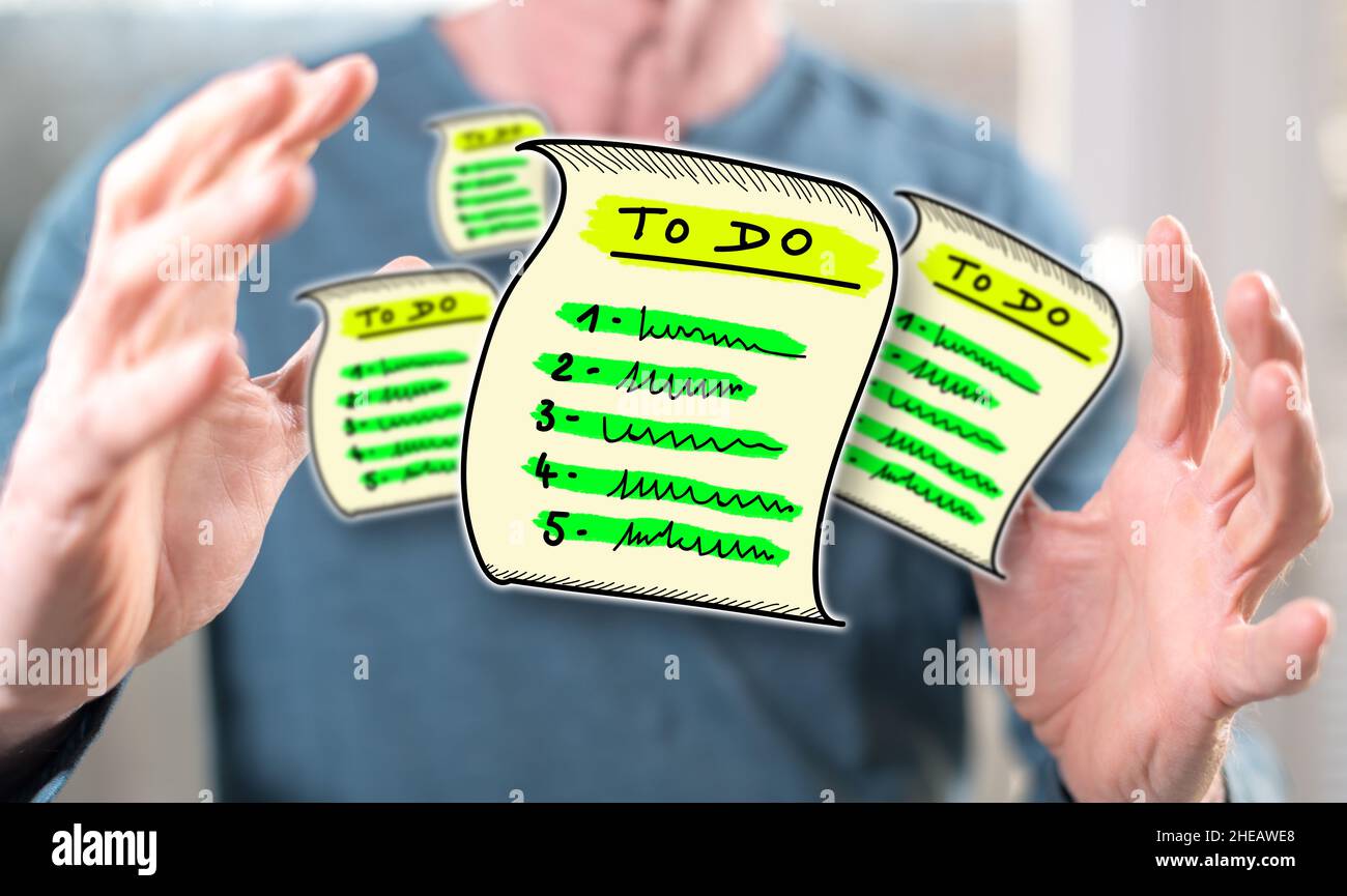 To do list concept between hands of a man in background Stock Photo - Alamy