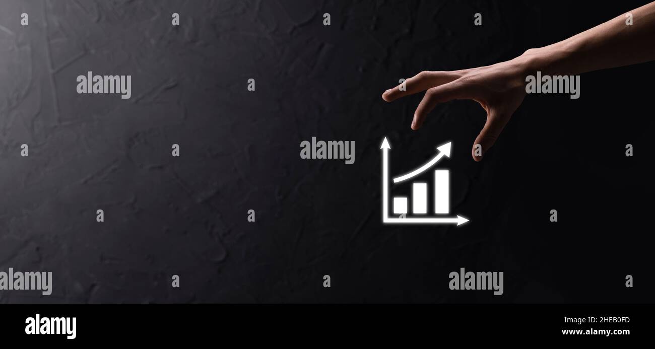 Businessman man holding a graph with positive profits growth. plan ...