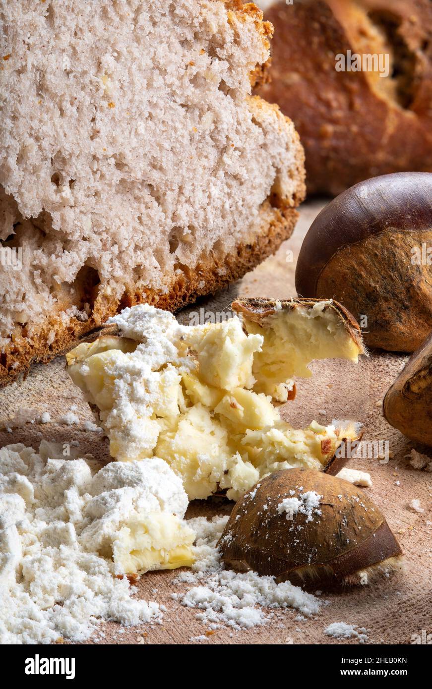 A loaf of bread made with chestnut flour with whole chestnuts on a ...