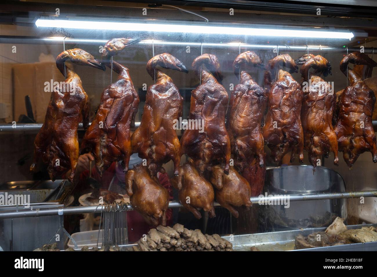 Chinese restaurant window with crispy Peking Ducks hanging in the ...