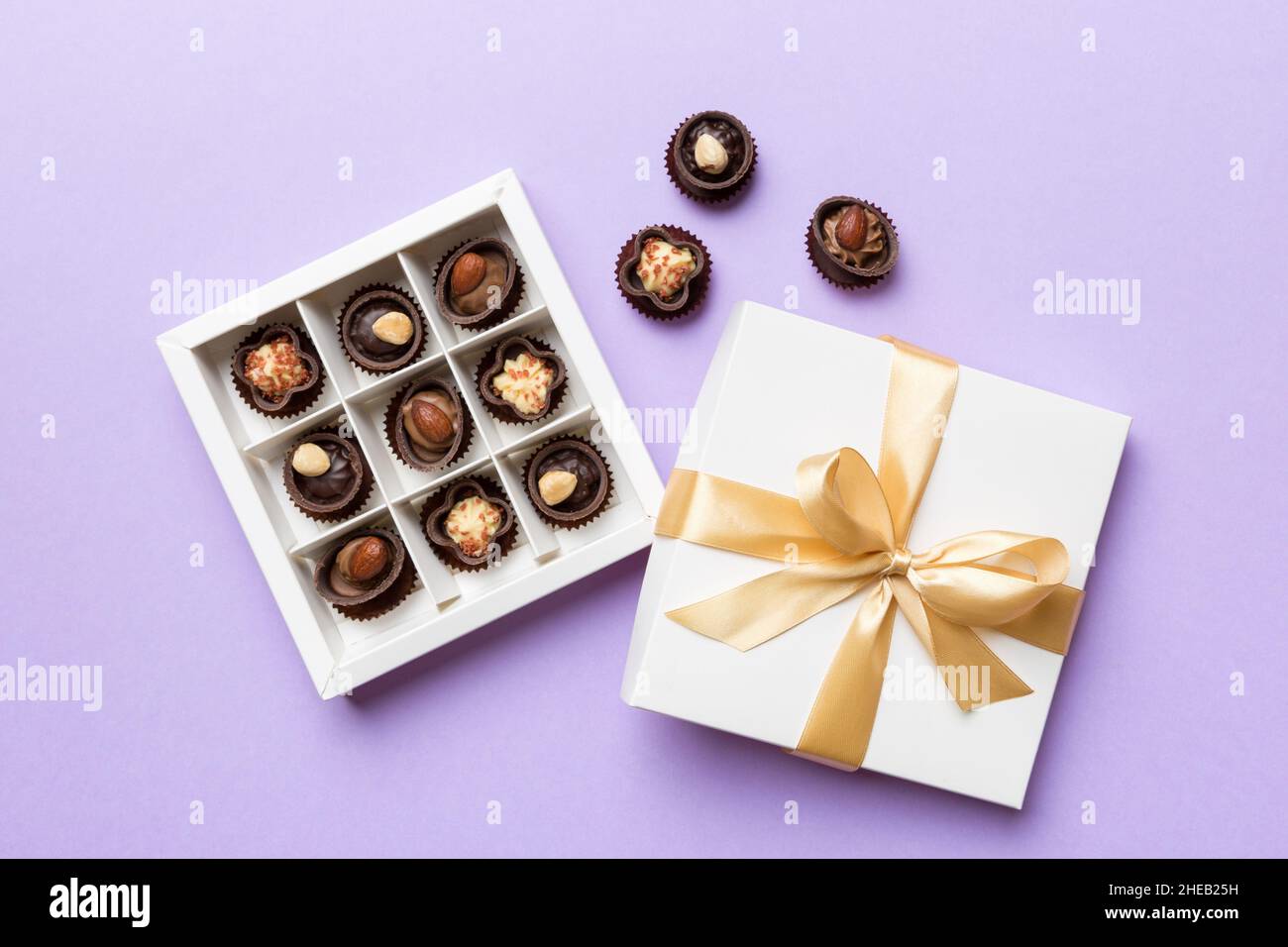 White box with chocolates candies and golden tape. top view with copy ...