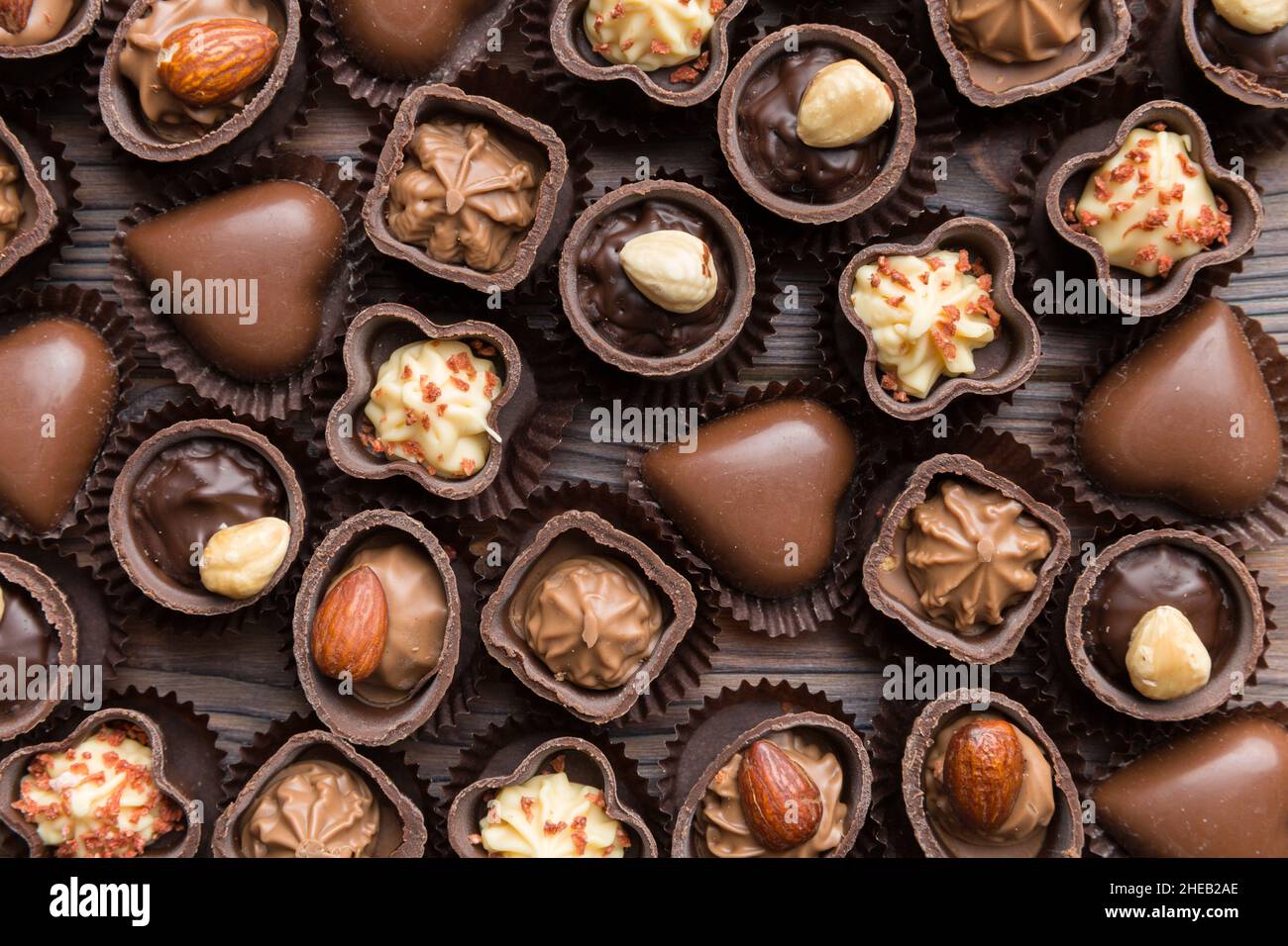 Different kinds of chocolates on colored table close-up. Top View and ...