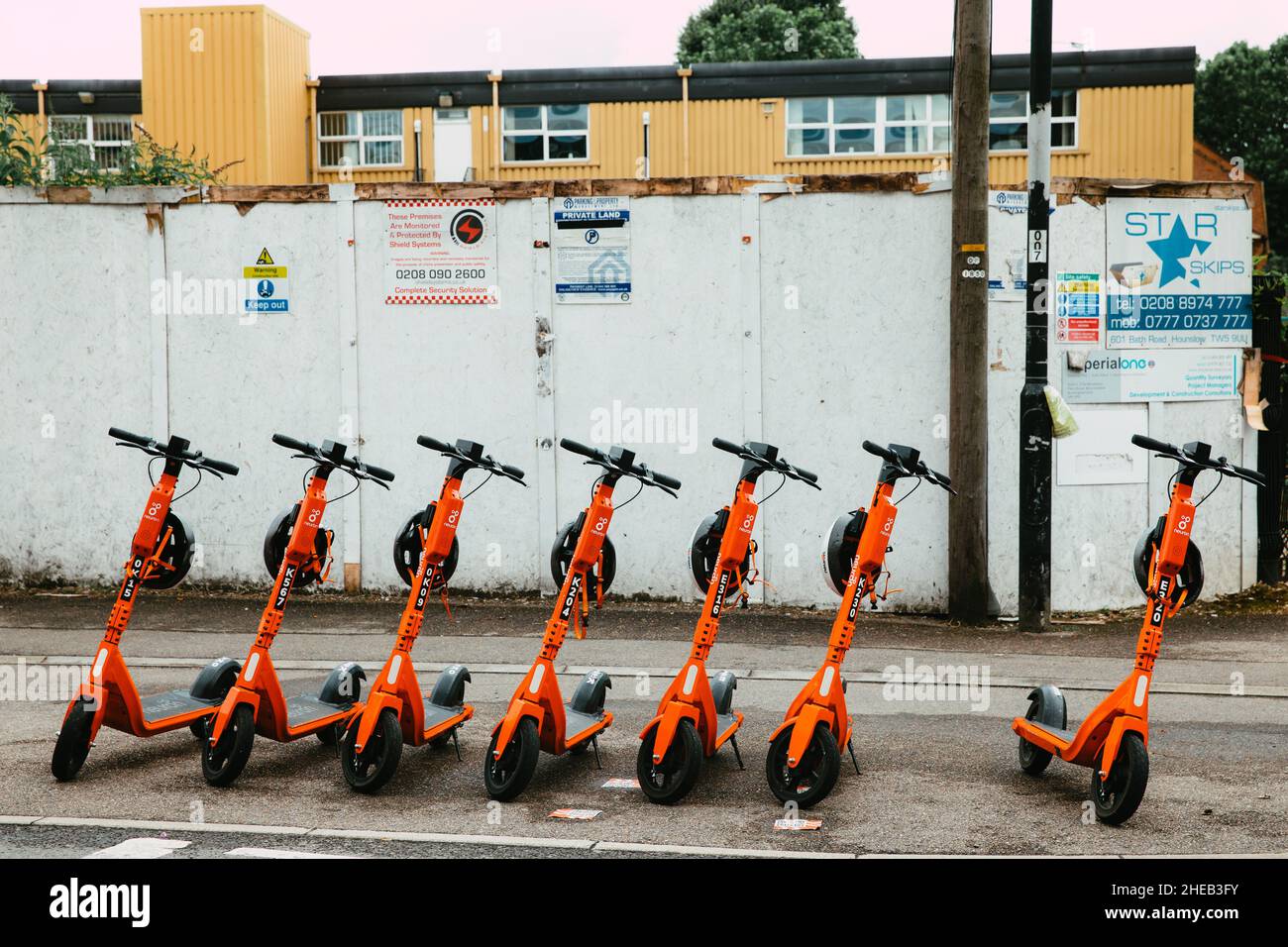 Slough, UK. 10th July, 2021. A row of Neuron Mobility e-scooters ...
