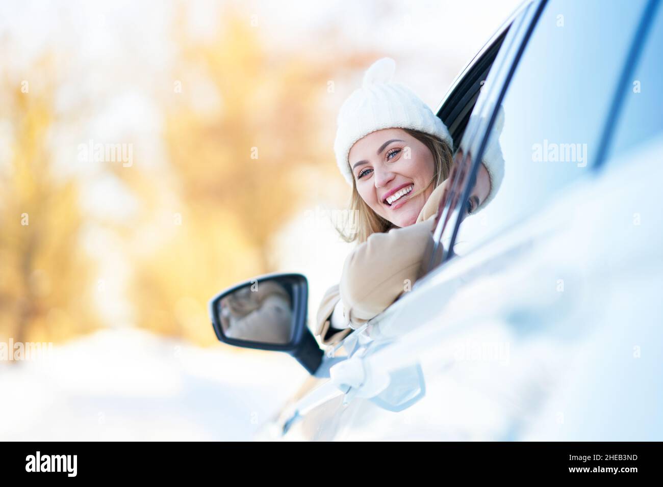 Happy woman driving car in snowy winter Stock Photo - Alamy