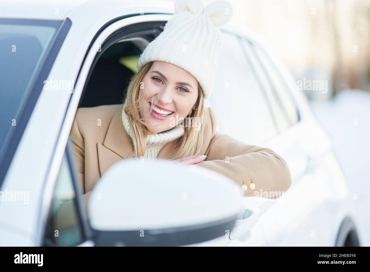Happy woman driving car in snowy winter Stock Photo - Alamy