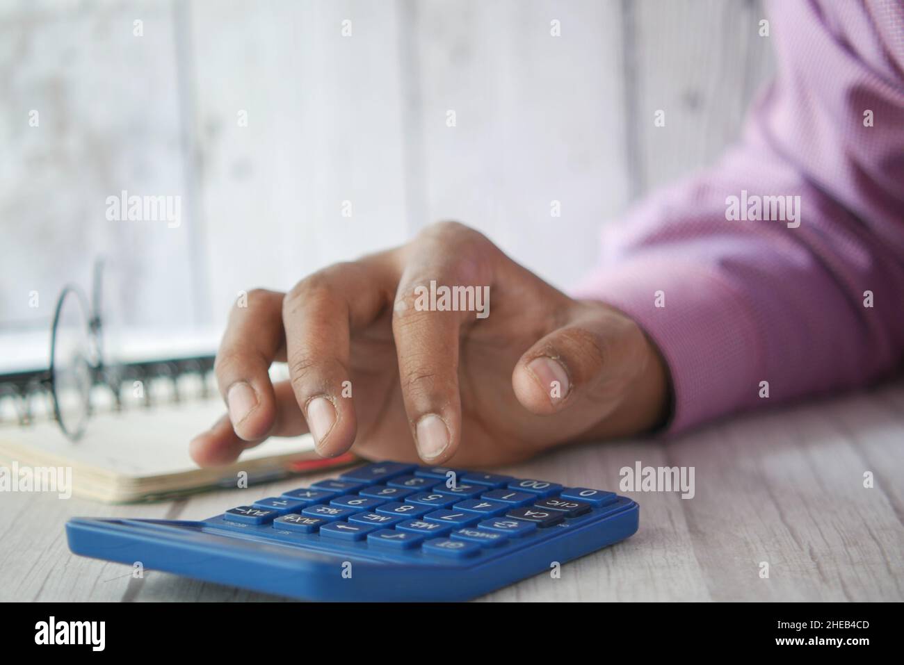 Hand using calculator hi-res stock photography and images - Alamy