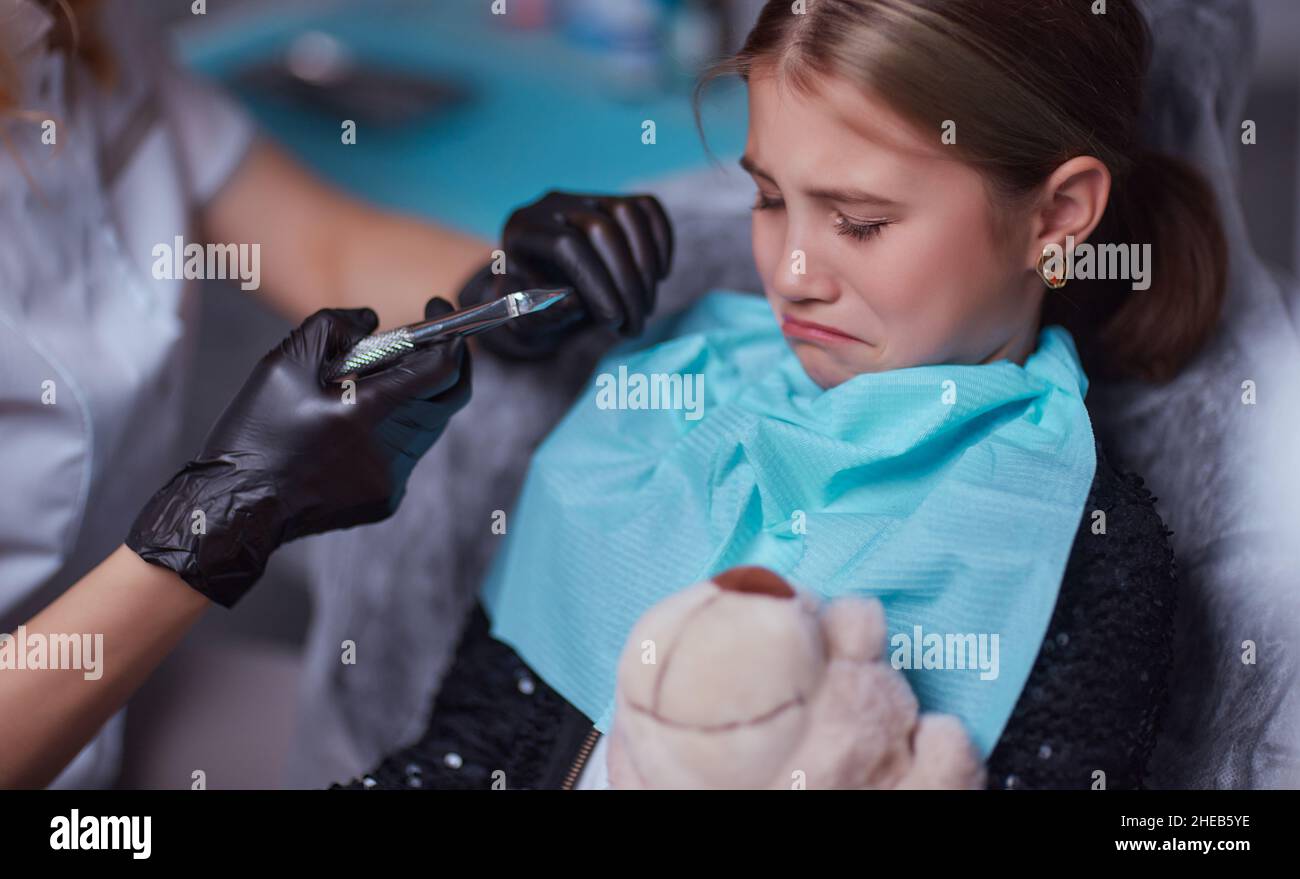 Dentist use anesthetic injection for tooth extraction in child Stock ...