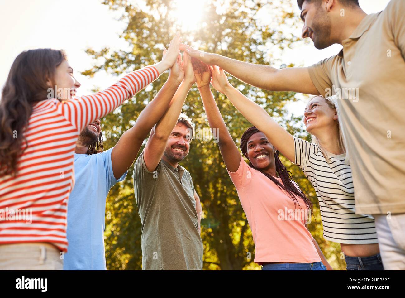 Multicultural start-up team at the high five for team building and ...