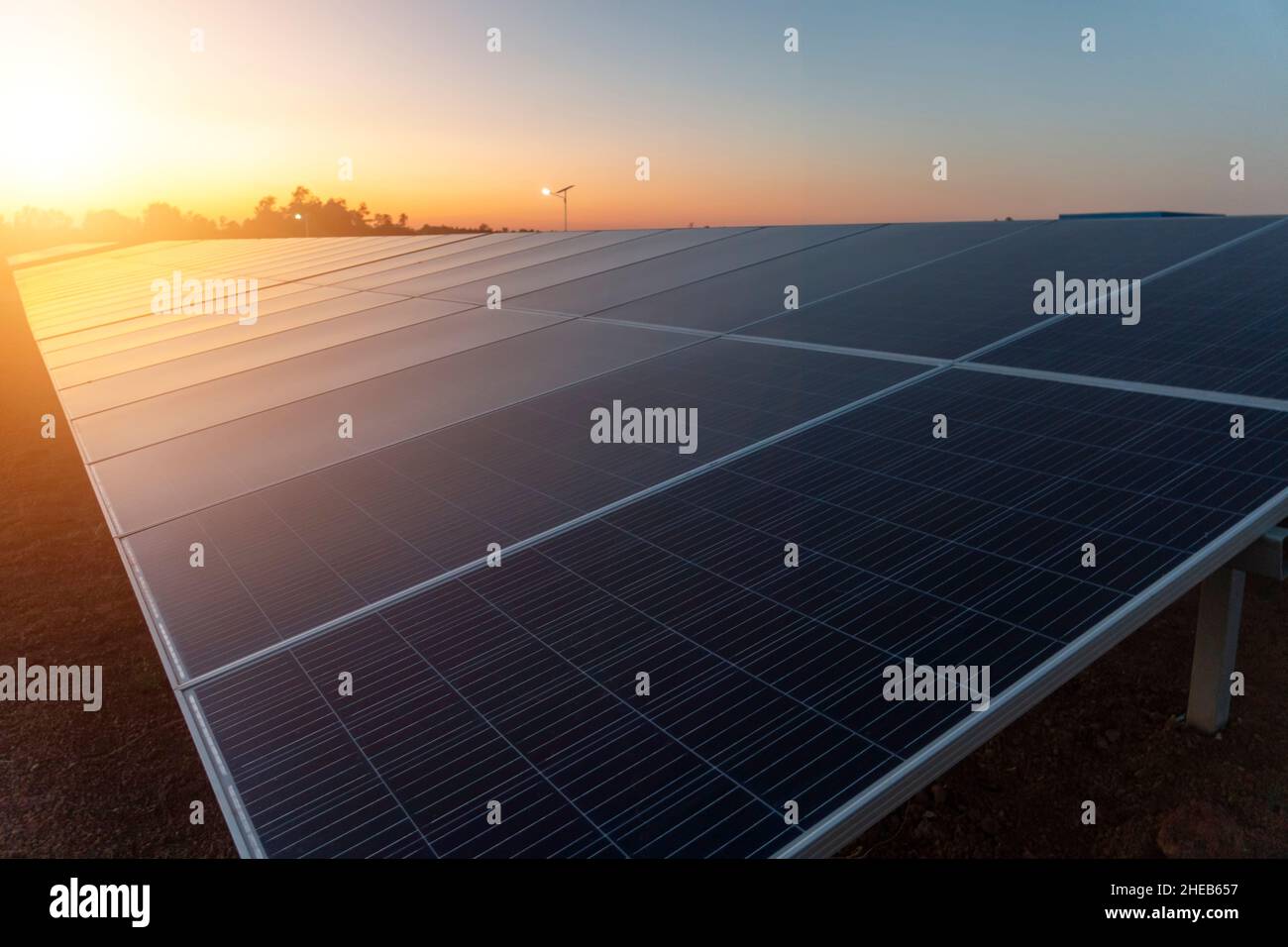 Sunset solar panel electric clean energy to the future Stock Photo - Alamy