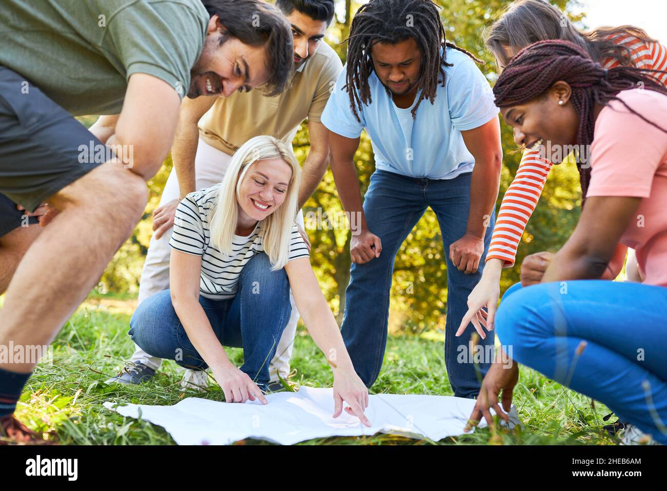 Start-up team people look at the map during the treasure hunt in the ...