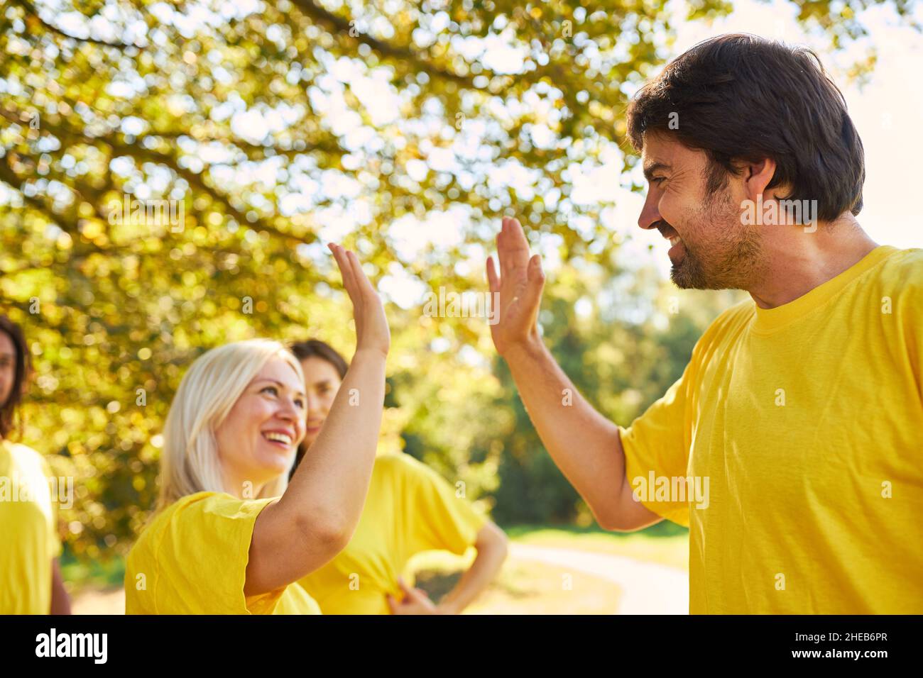 Young people at the high five give as a team building exercise for ...