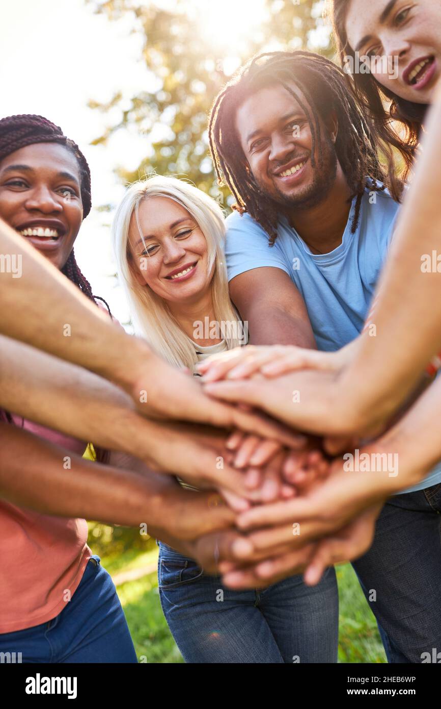 Happy start-up team stacking hands for network and team building in the ...