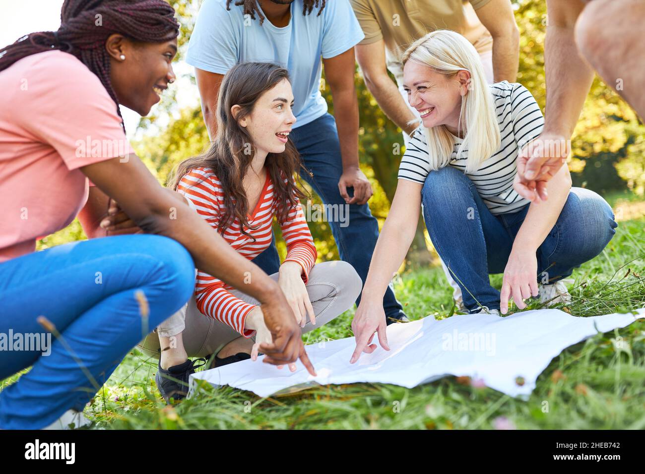 Group of young people doing geocaching as a scavenger hunt for teamwork ...