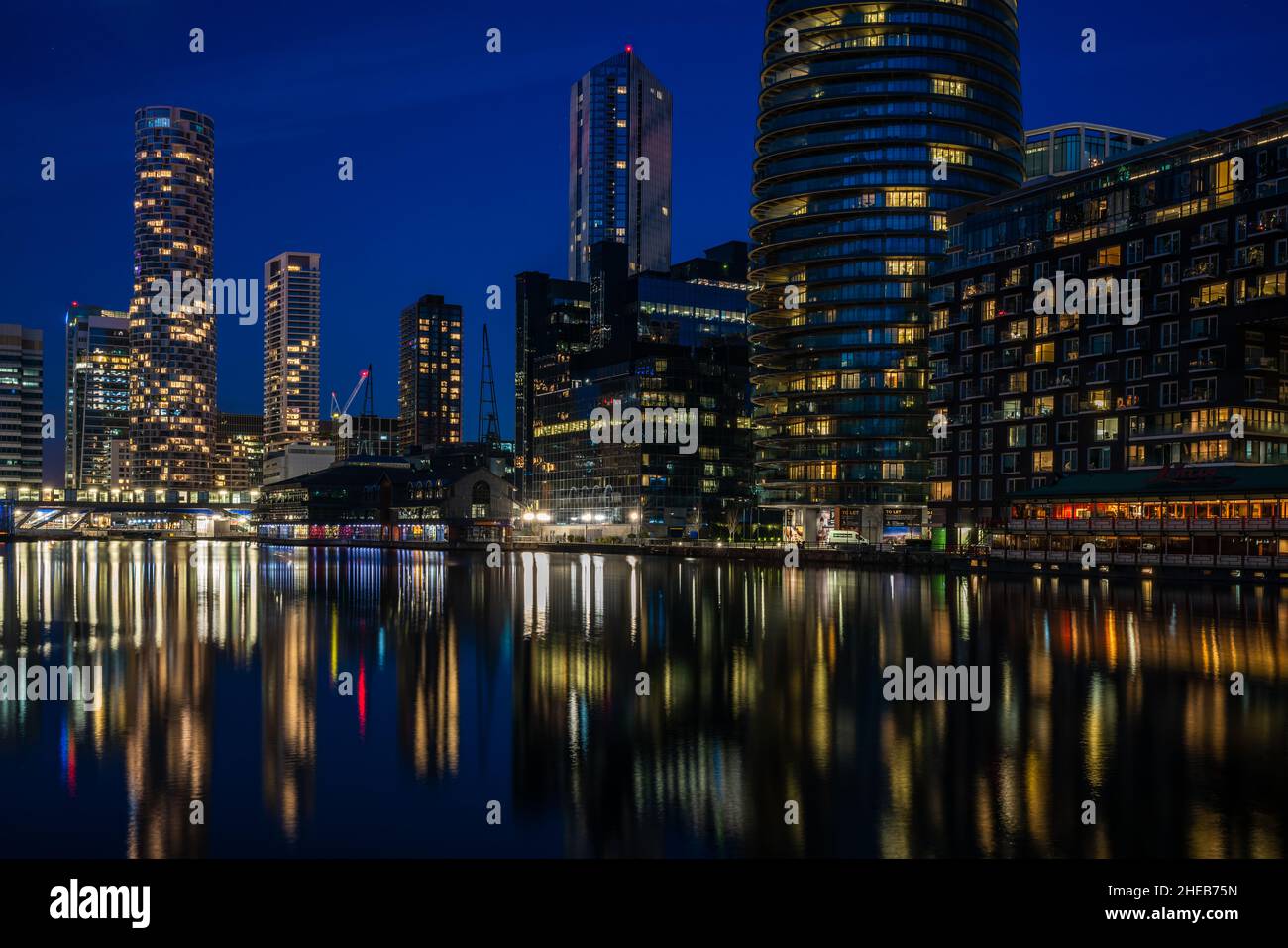 Night view of modern skyscrapers across Millwall Inner Dock in Canary ...