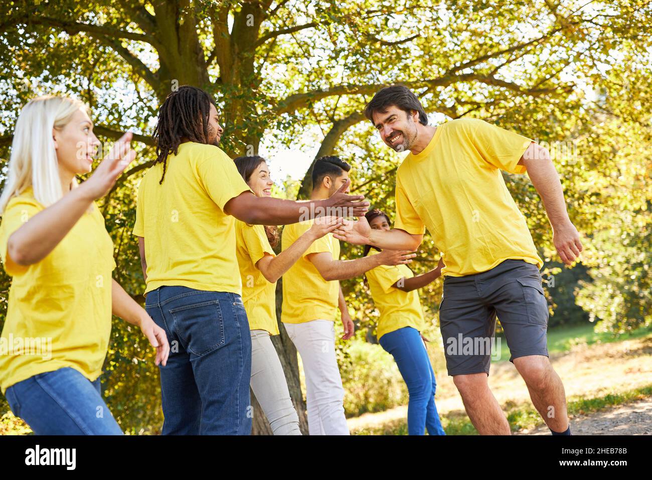 Young people clapping in fitness competition for team building and ...