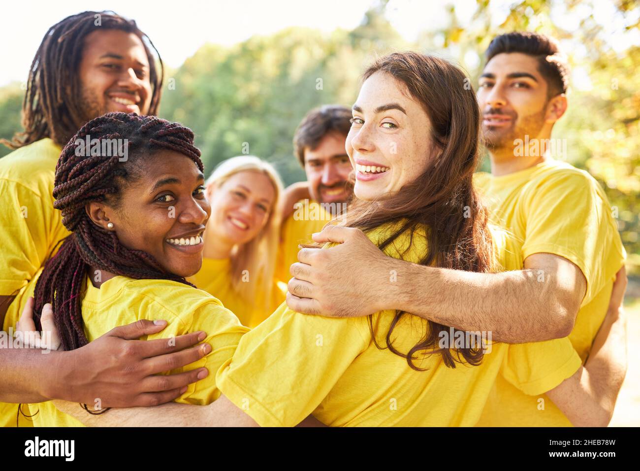 Multicultural people in the start-up team embrace each other for ...