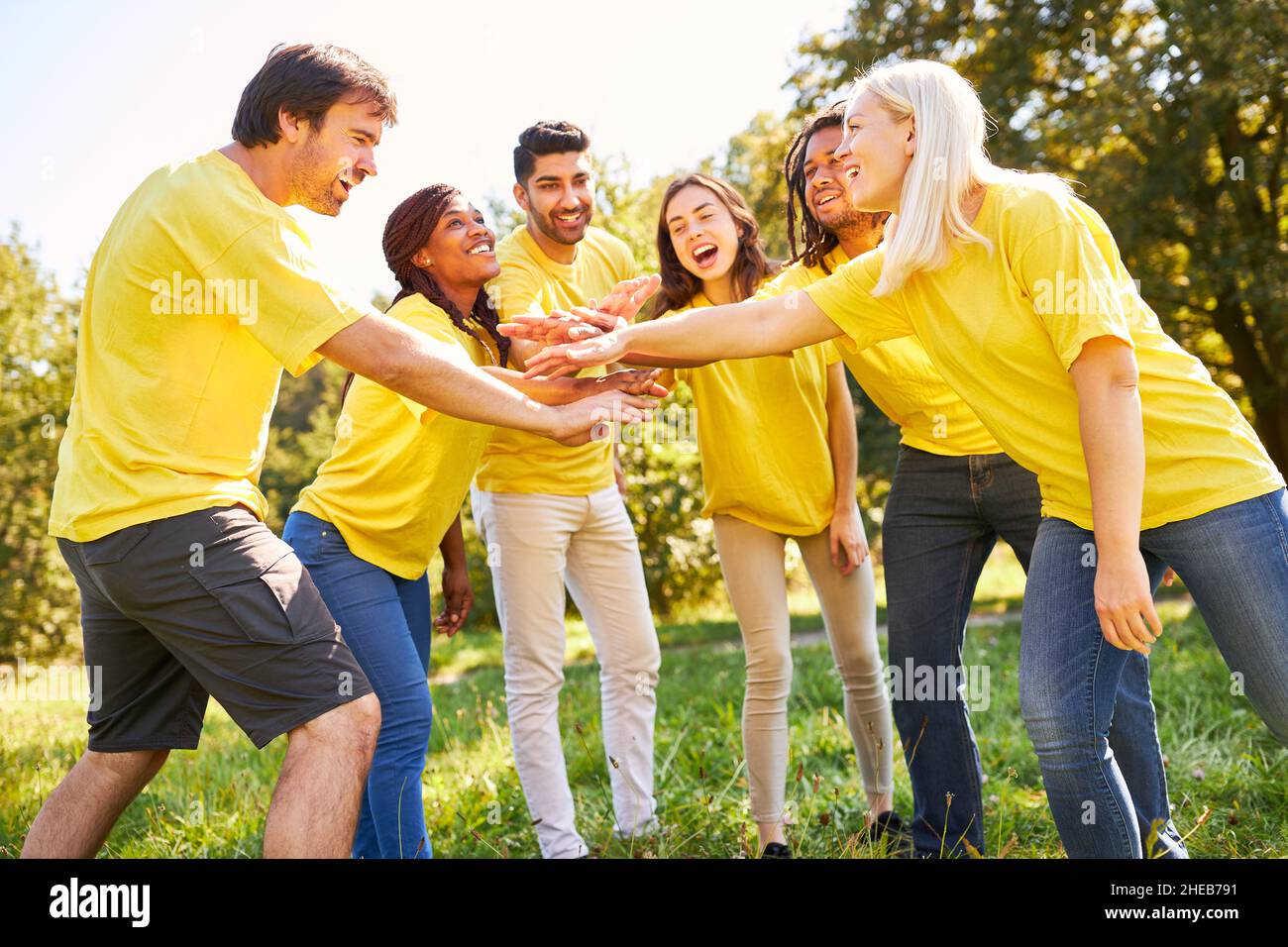 Group of young people stacking hands for motivation and team building ...