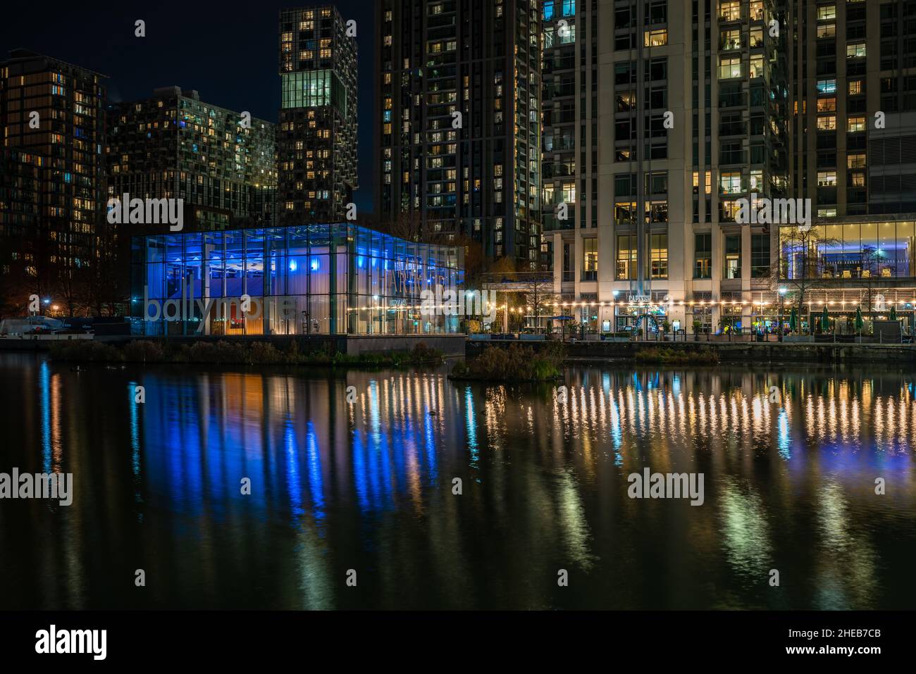 Night view of modern skyscrapers across Millwall Inner Dock in Canary ...