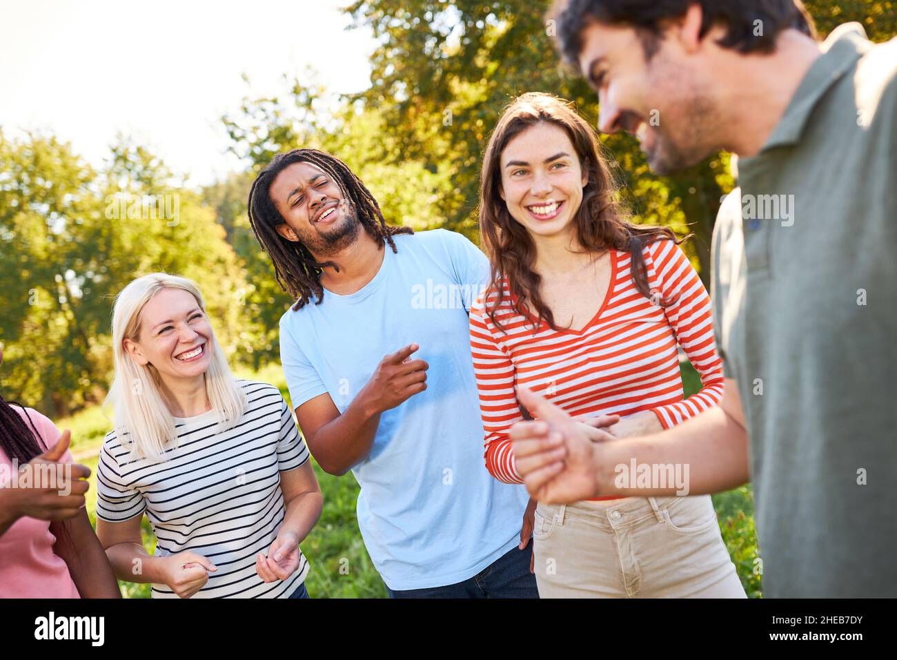 Group of multicultural students making small talk on a nature excursion ...