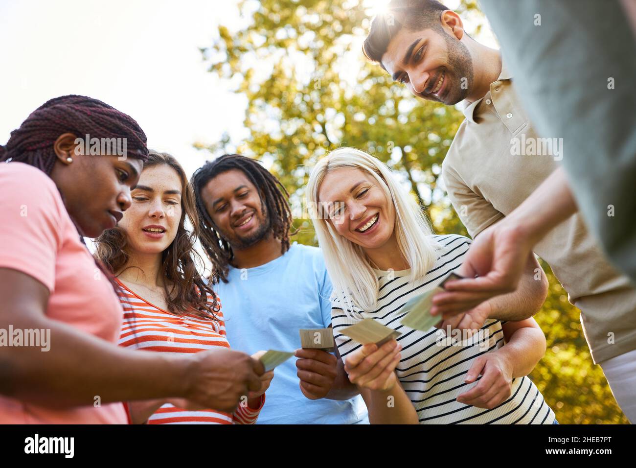 Young people work together to solve a task in an outdoor team building ...