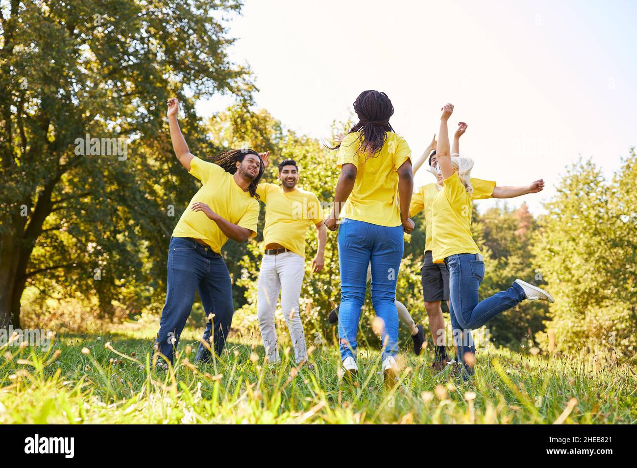 Young people jump and hop together as a summer team building exercise ...
