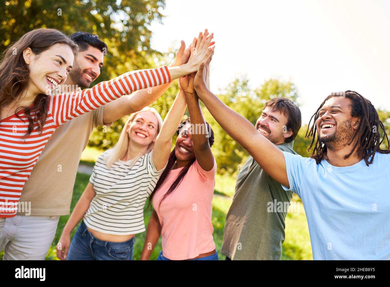 Group of diverse young people celebrate integration and friendship in ...
