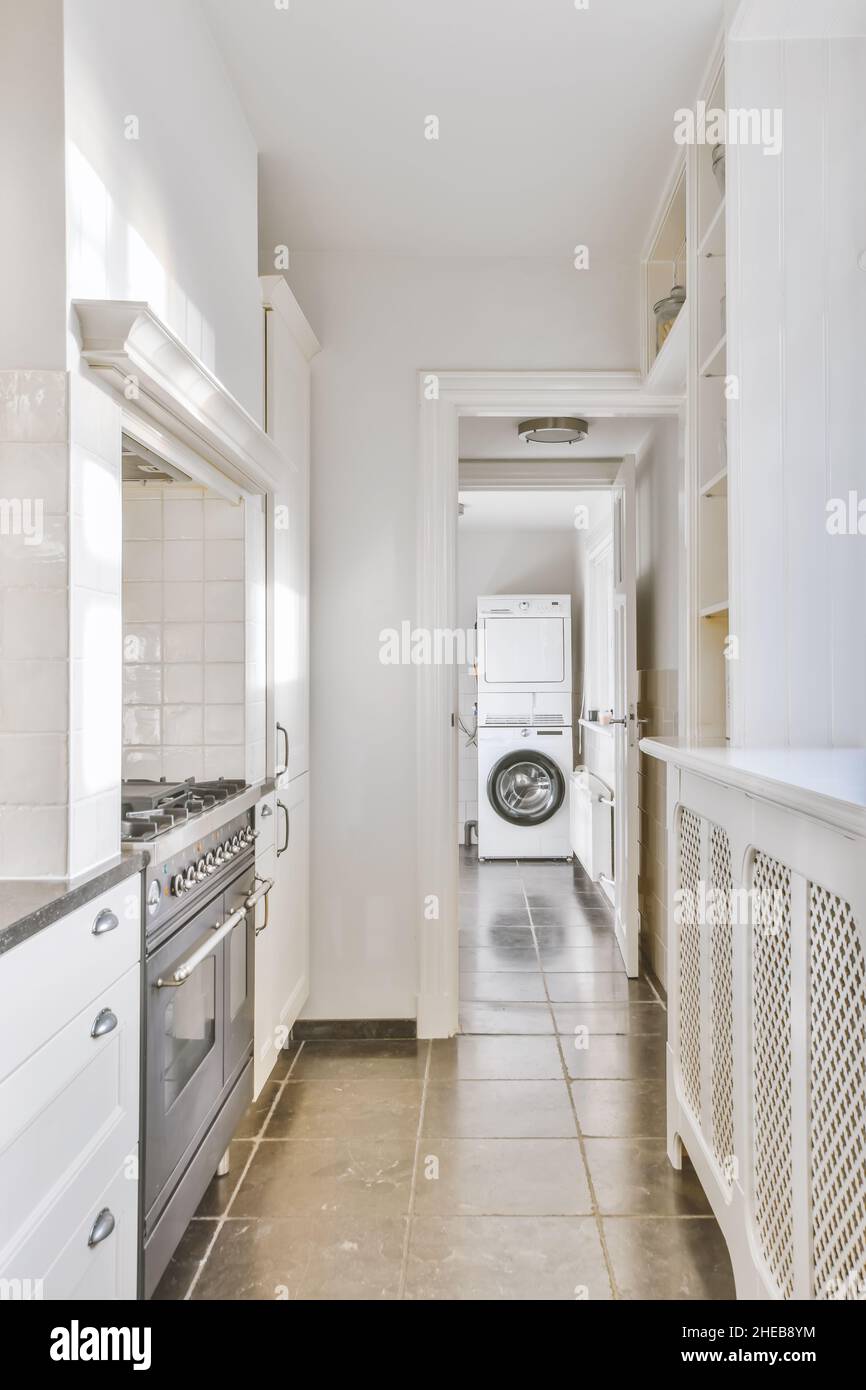 Long bright corridor with an open door leading to the laundry Stock ...