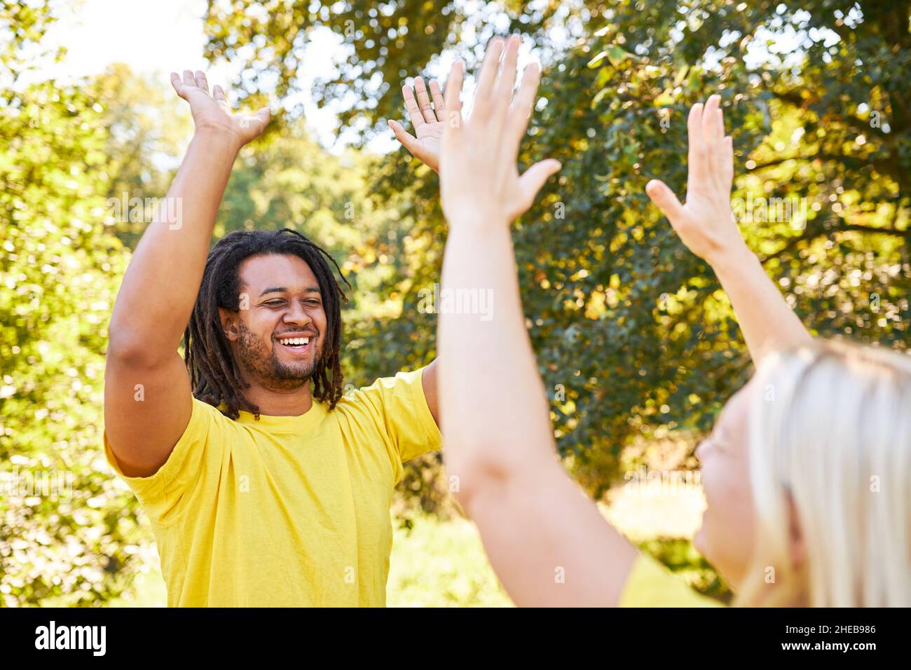 Young people at the high five for motivation and cooperation in the ...